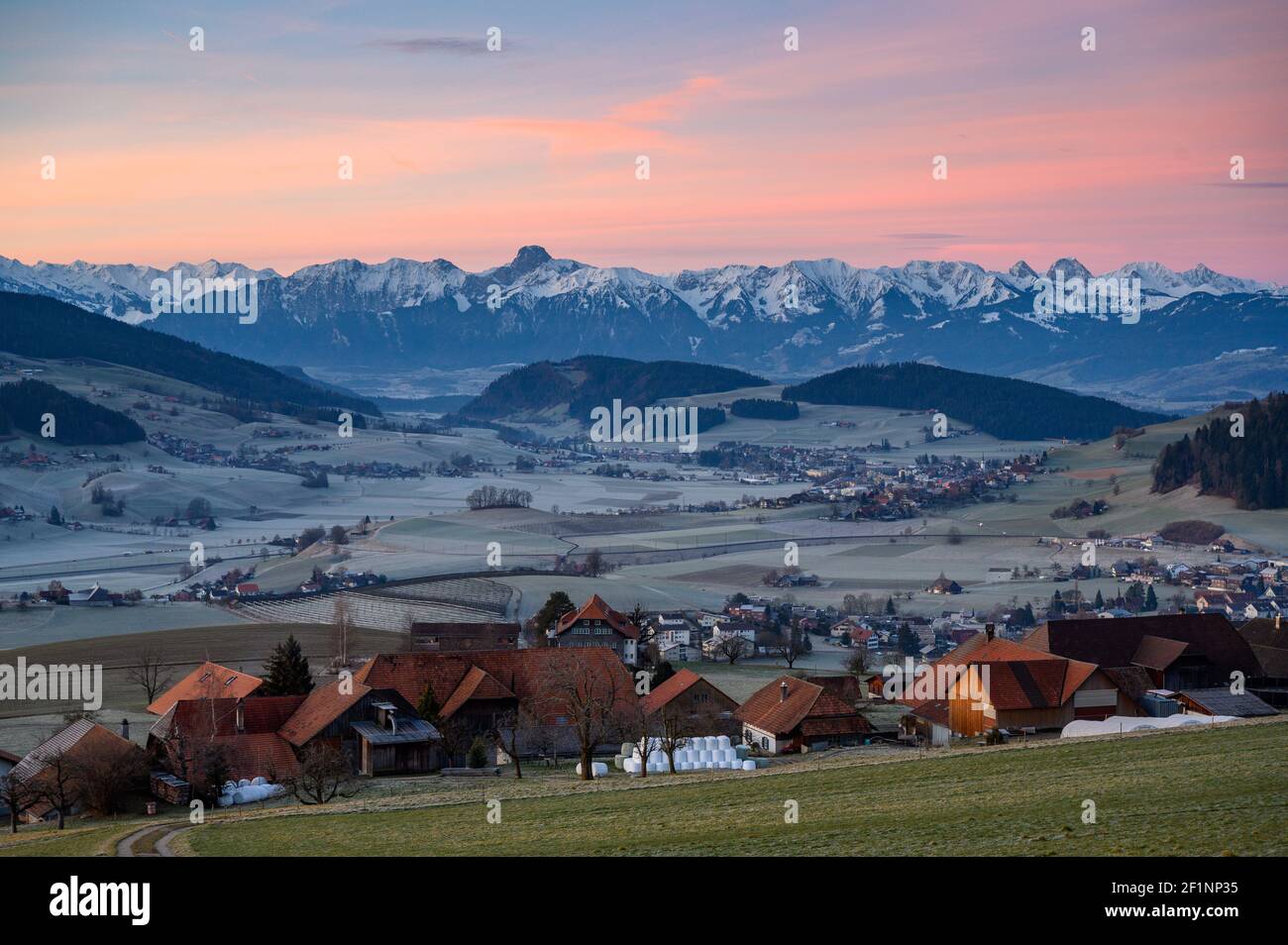 village of Konolfingen at sunset with hills of Emmental and Stockhorn ...