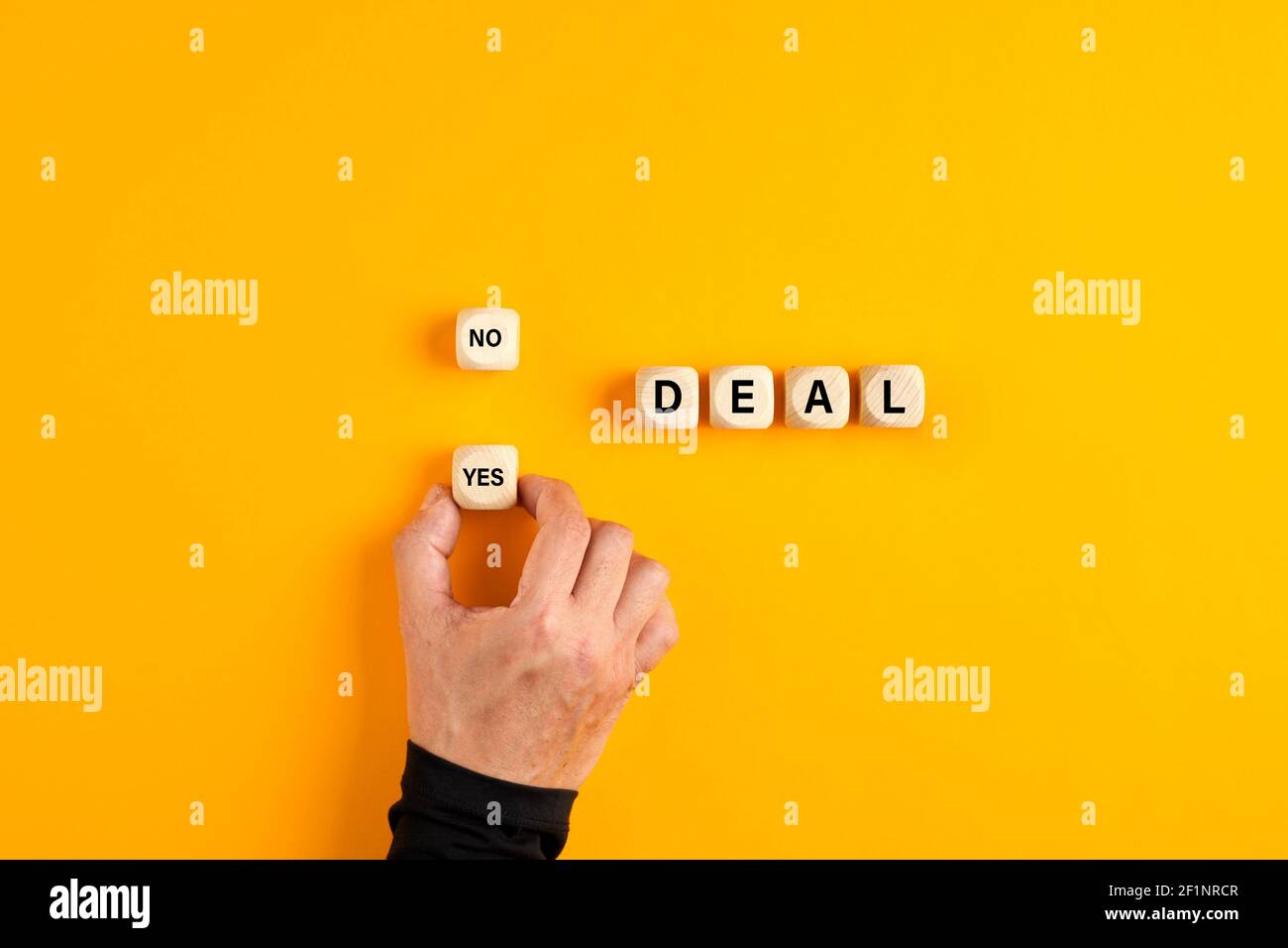 The word deal on wooden blocks with a male hand choosing the yes option ...