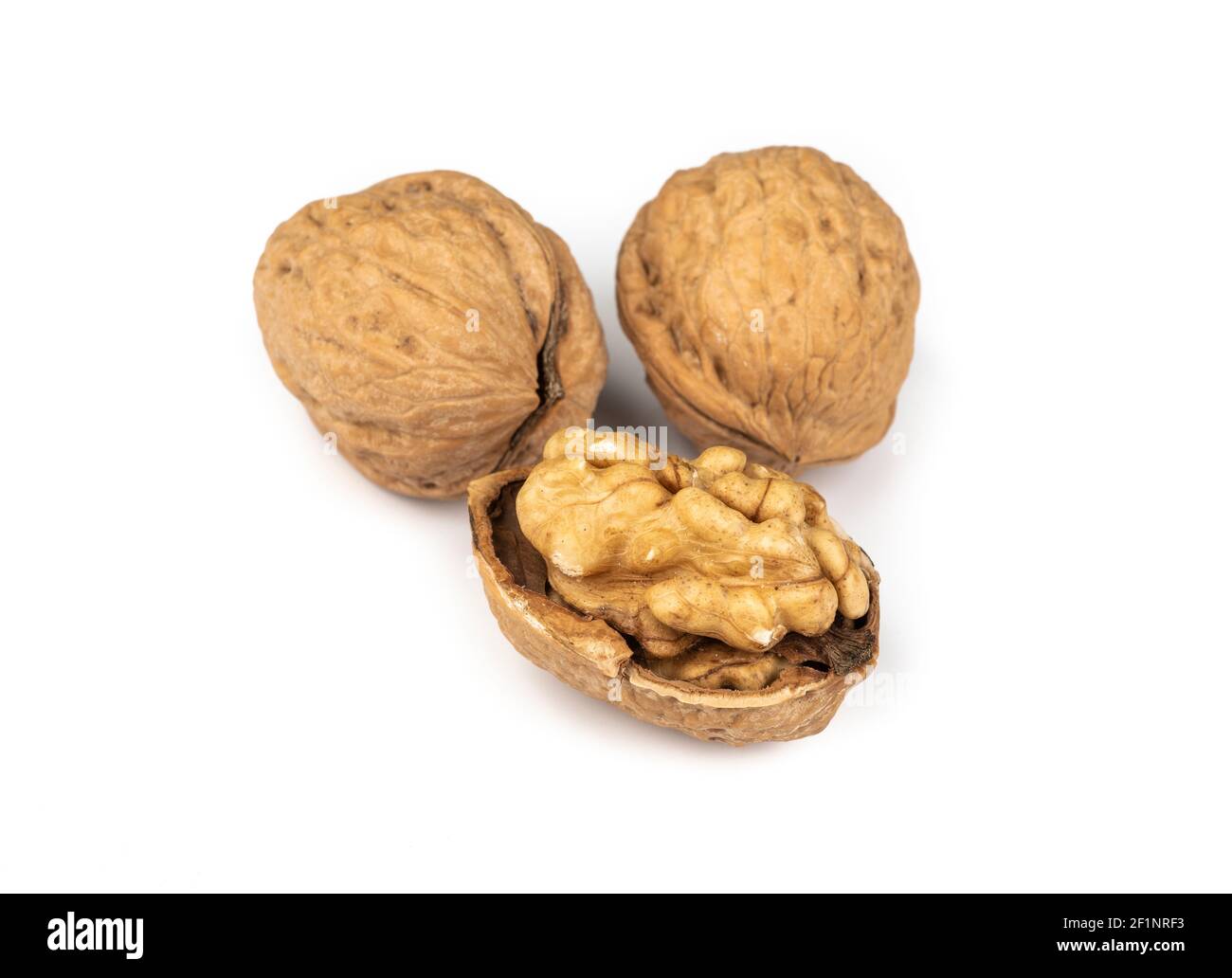 Walnuts and cut nut isolated over white background Stock Photo - Alamy