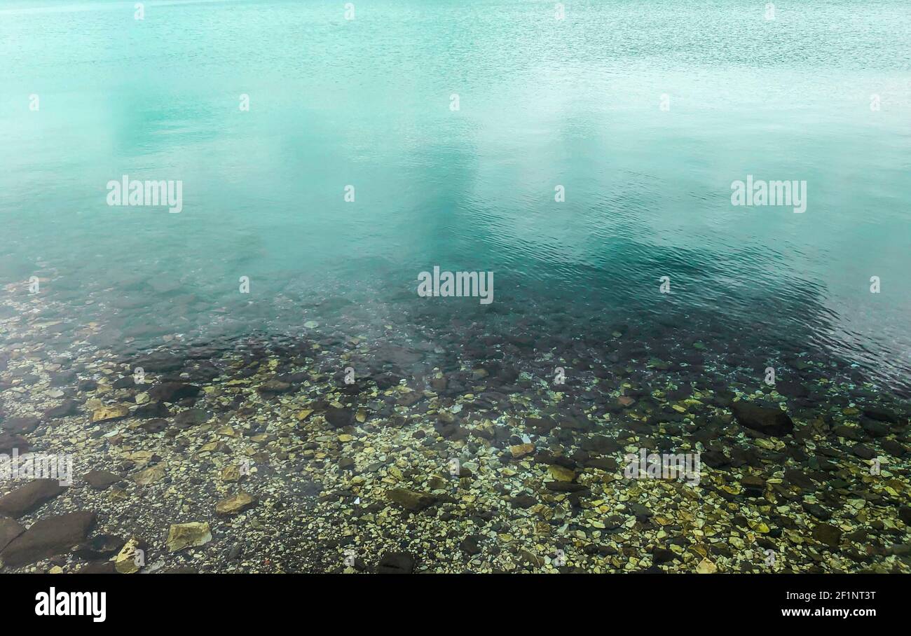 Crystal clear water with little rocks underwater. Natural sea ...