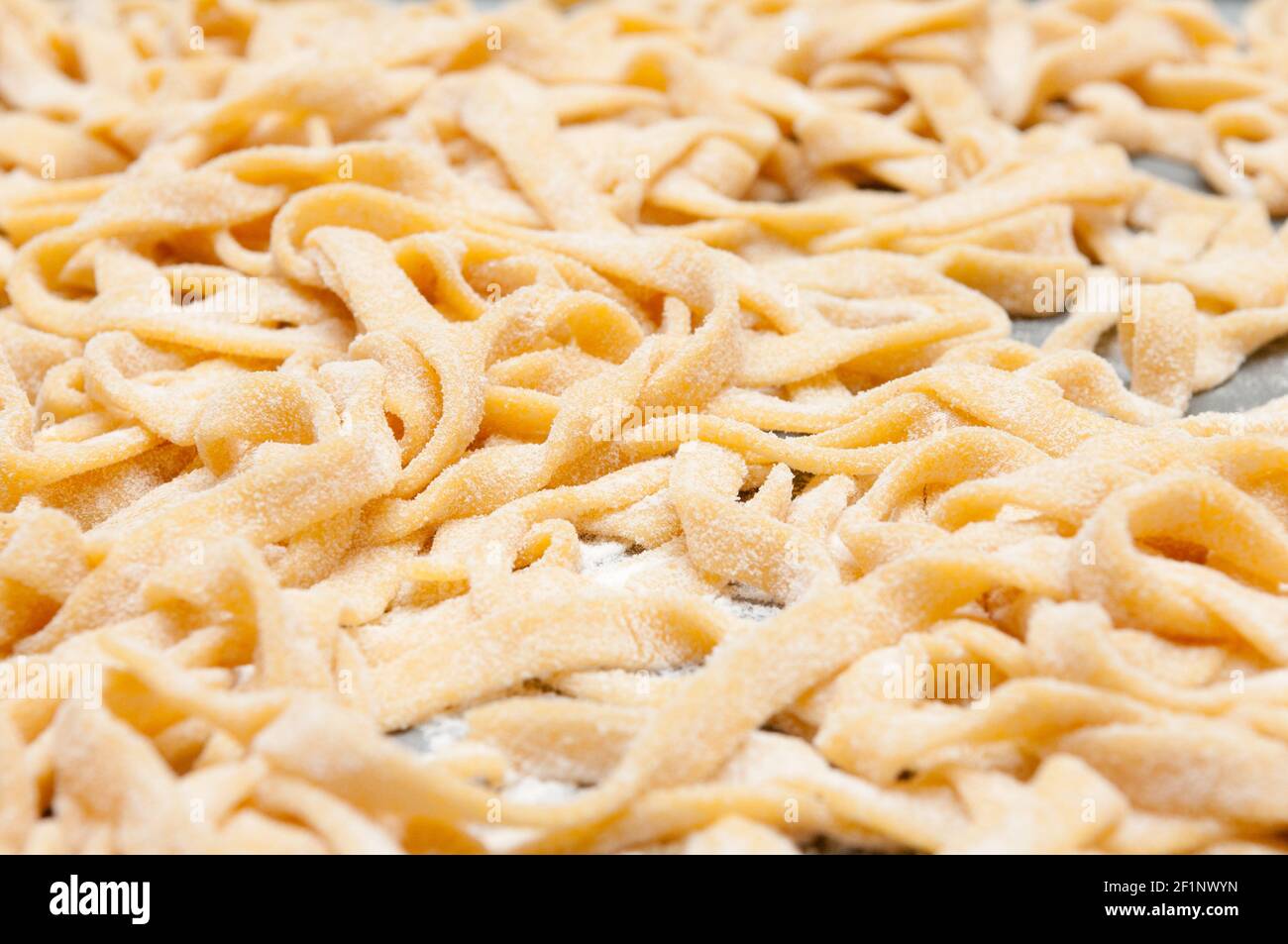 fresh made pasta dough cut into fettuccine Stock Photo - Alamy