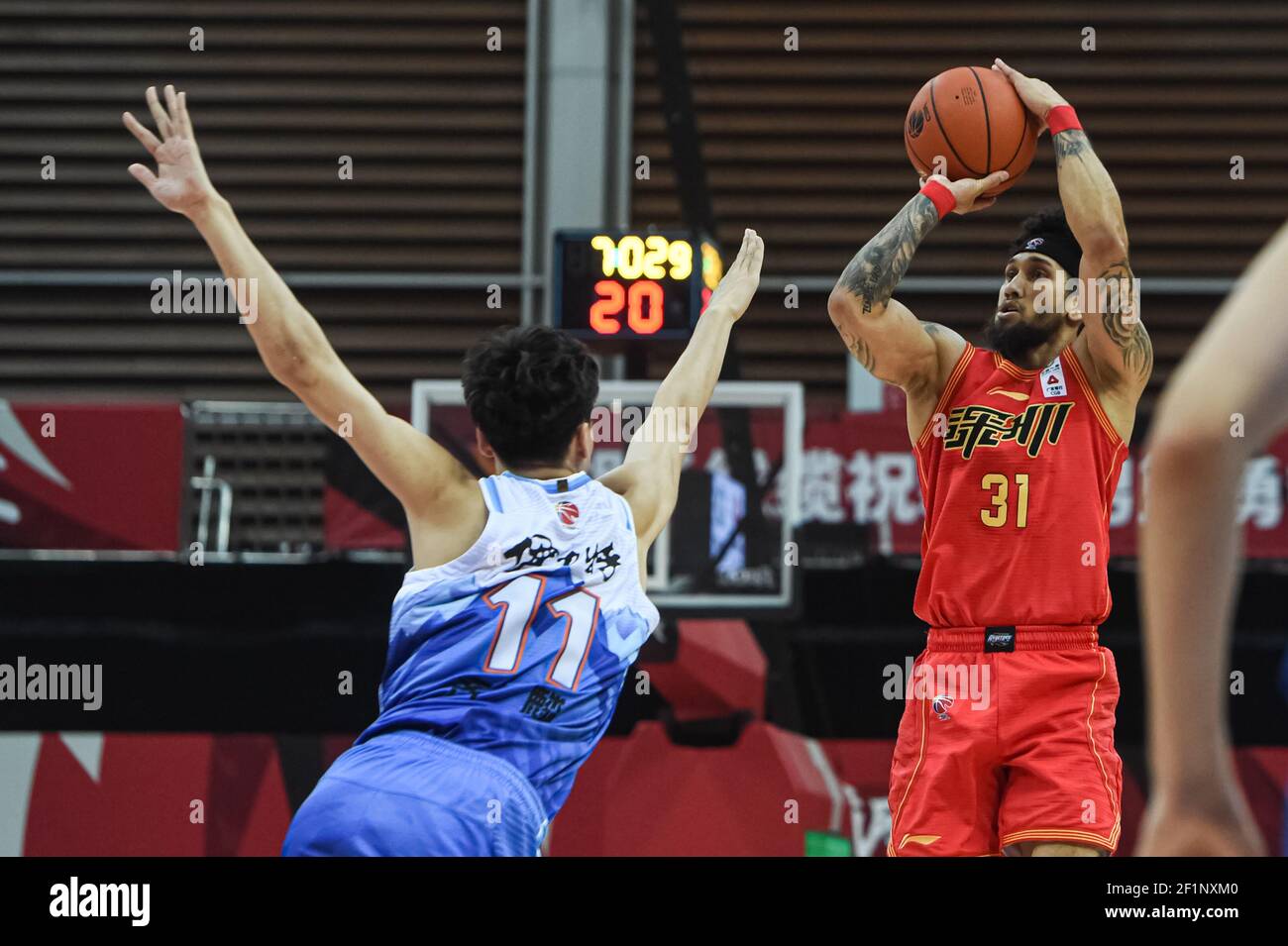 Zhuji, China's Zhejiang Province. 9th Mar, 2021. Askia Booker (R) of ...