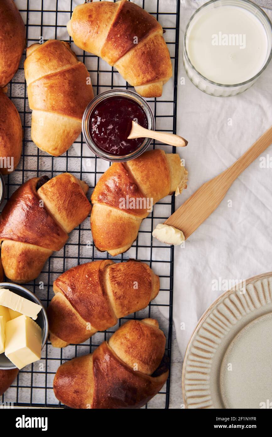 A vertical top view of deliciously prepared homemade croissants on a ...