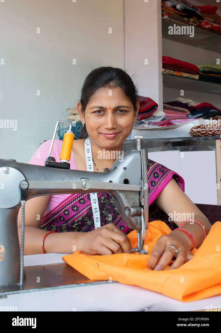 portrait of smiling young tailor or boutique owner Stock Photo - Alamy