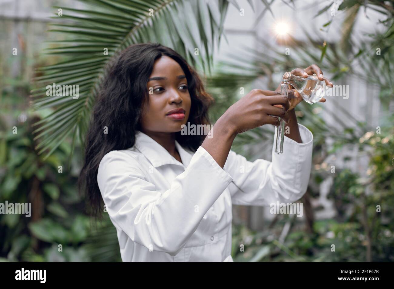 Pretty young confident african woman scientist biologist in white coat ...