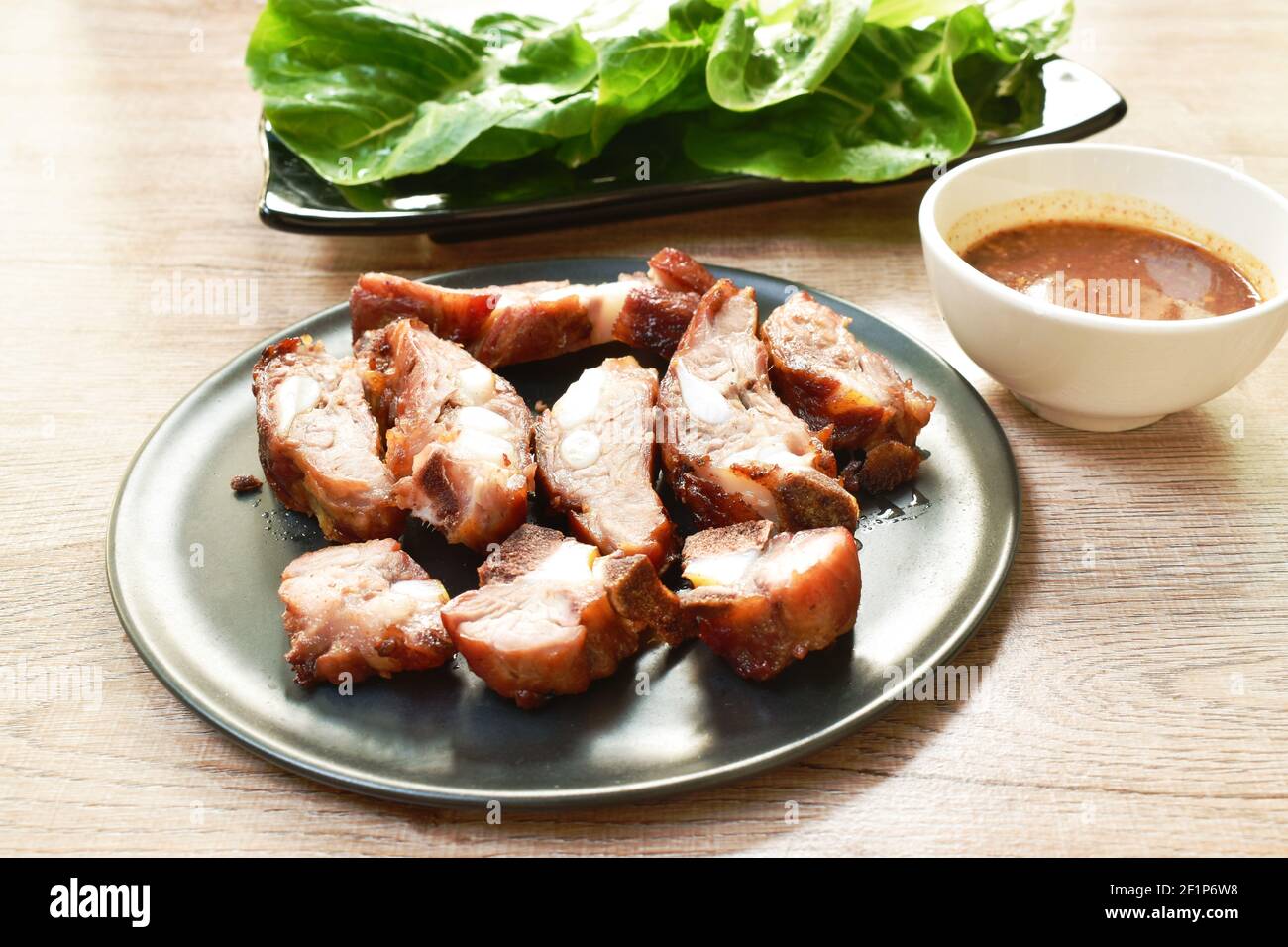 grilled pork bone slice dipping spicy chili sauce eat couple fresh cos ...