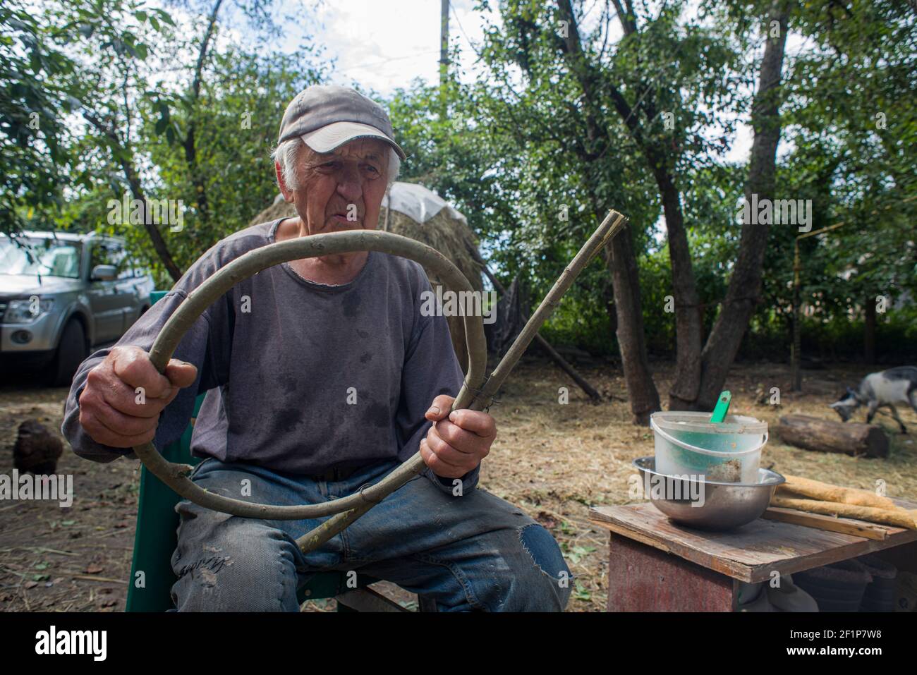 An old man, craftsman, bents furniture part Stock Photo - Alamy