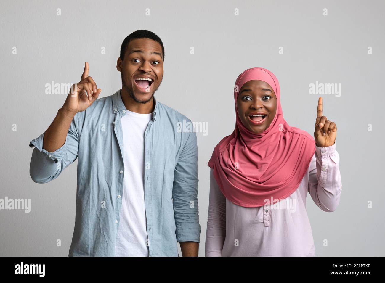 Emotional african american young lovers muslim couple cheerful guy and ...