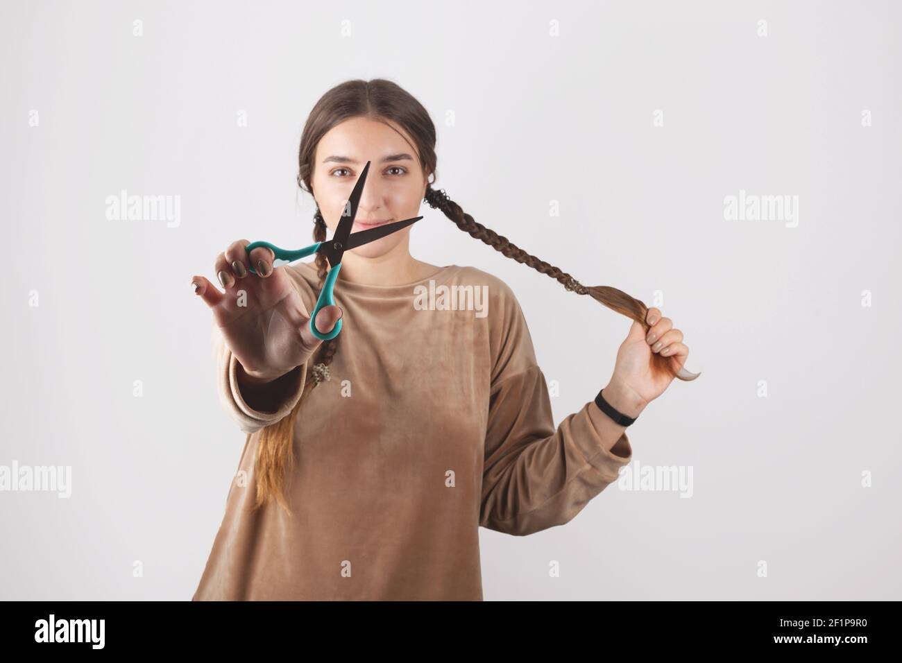 A woman cuts her long hair at home. Cardinal shocking image change ...