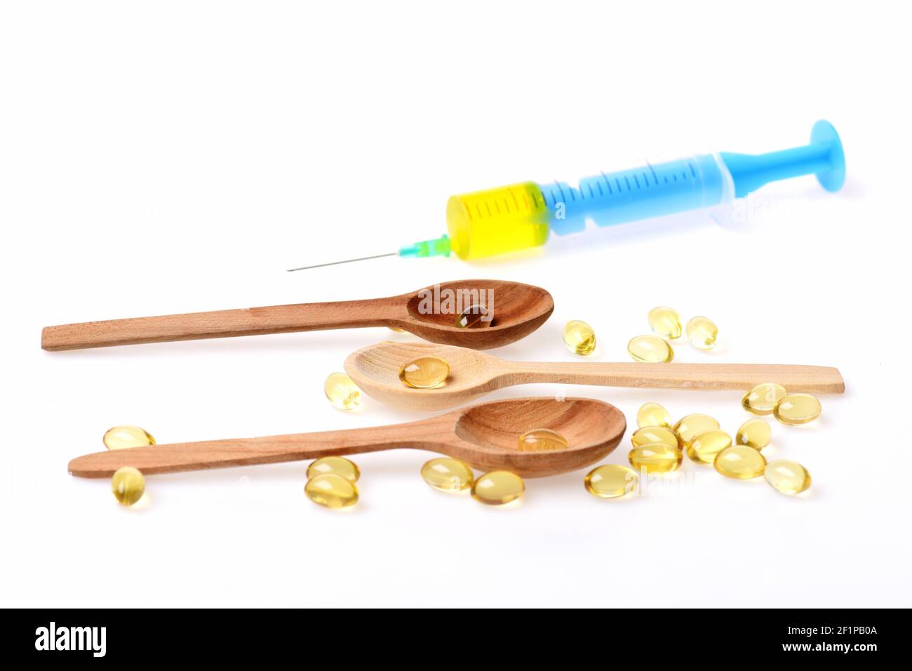 Syringe, capsules and wooden spoons isolated on white background. Omega ...