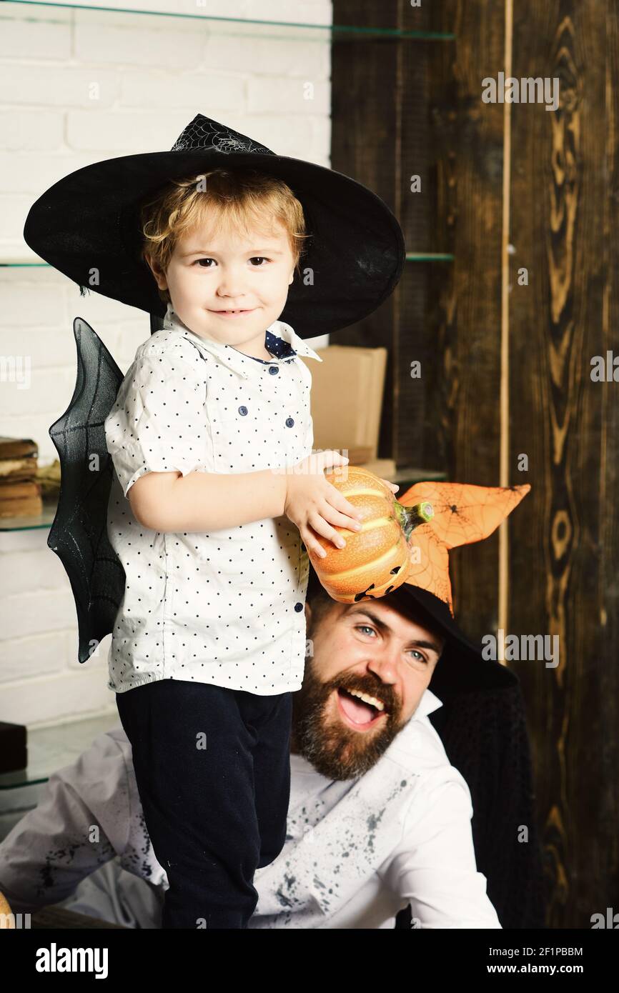 Witcher and little magician make Halloween decor. Guy and kid with ...