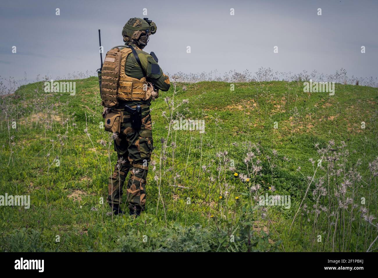 A back view of a fully equipped soldier on a military operation ...