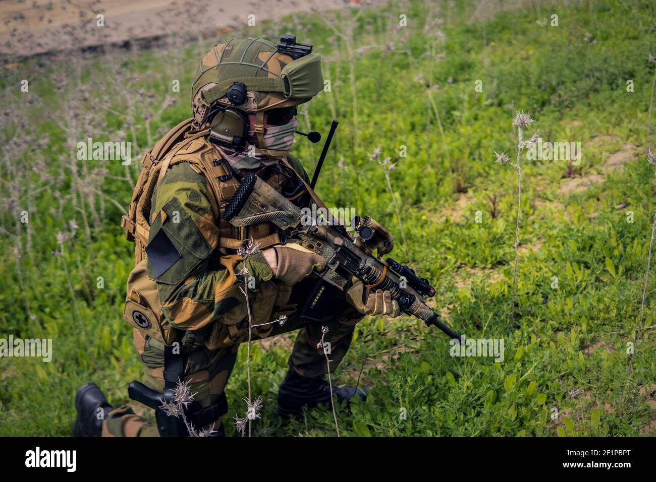 A closeup of a fully equipped soldier carrying out a military operation ...