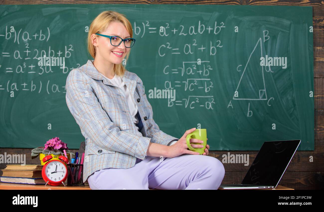Take a break to relax. Woman smiling teacher holds mug drink sit table ...