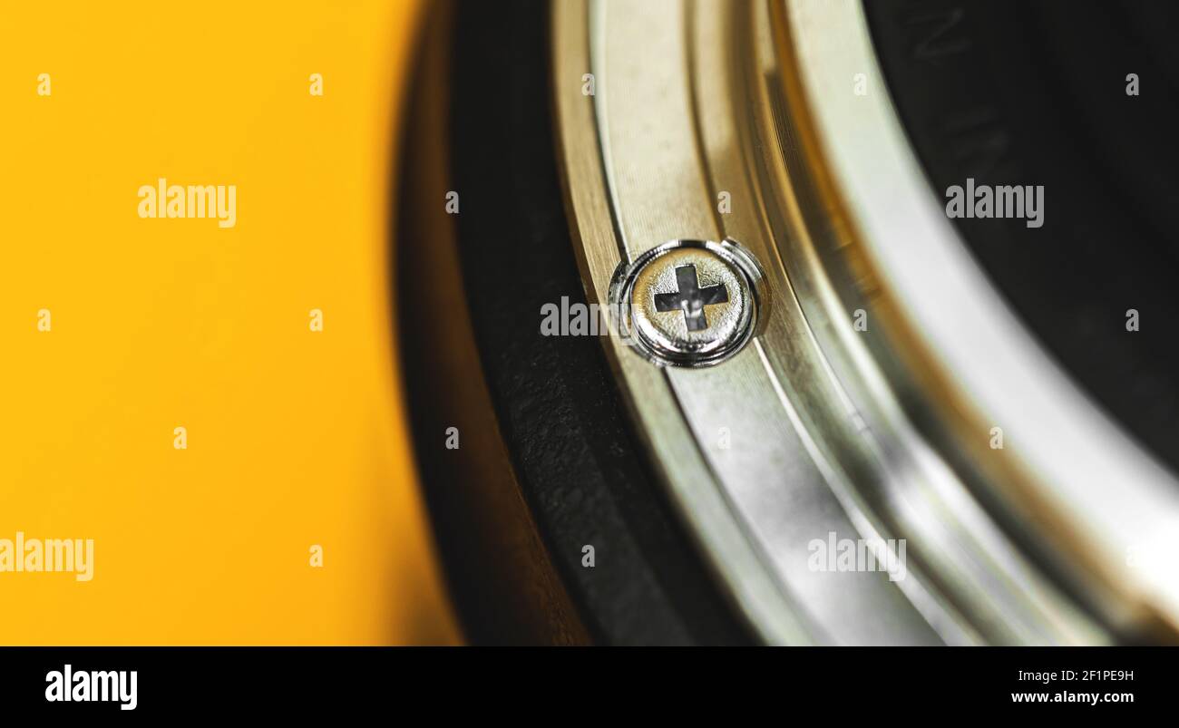 Camera lens repair, macro photo of steel bayonet mount ring, yellow ...