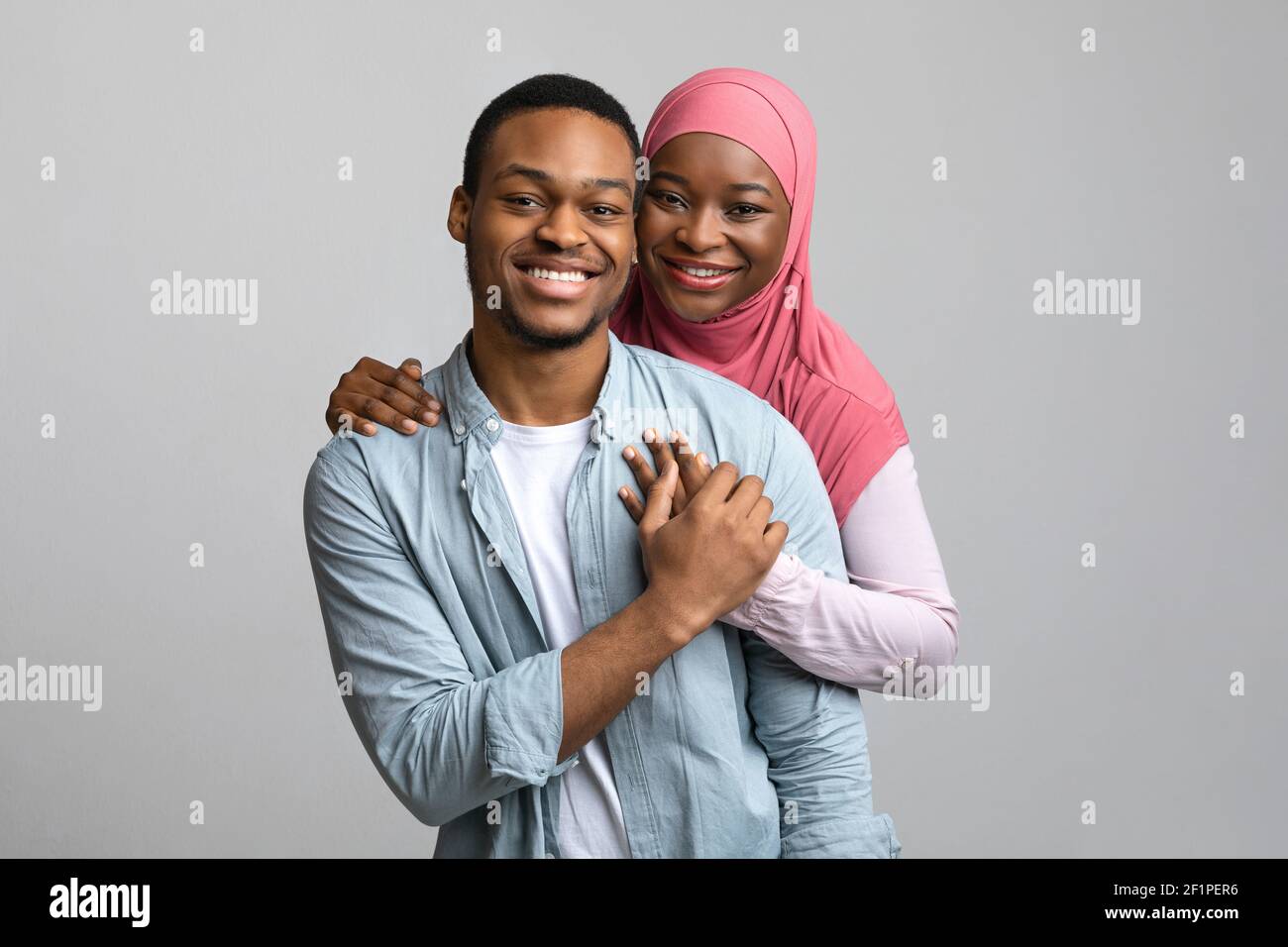 Romantic african american muslim couple posing together over grey ...
