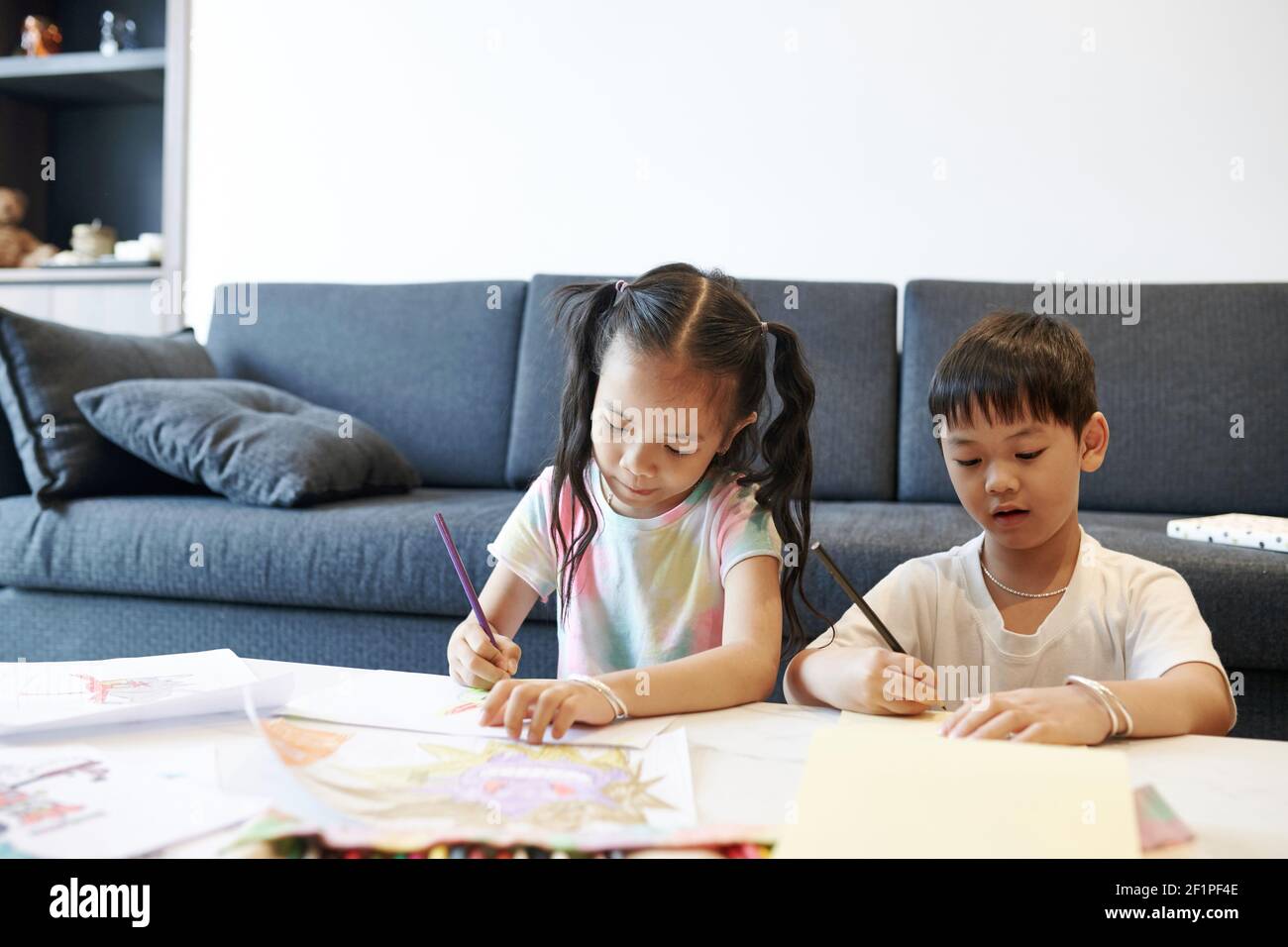 Talented creative Vietnamese brother and sister enjoying drawing ...