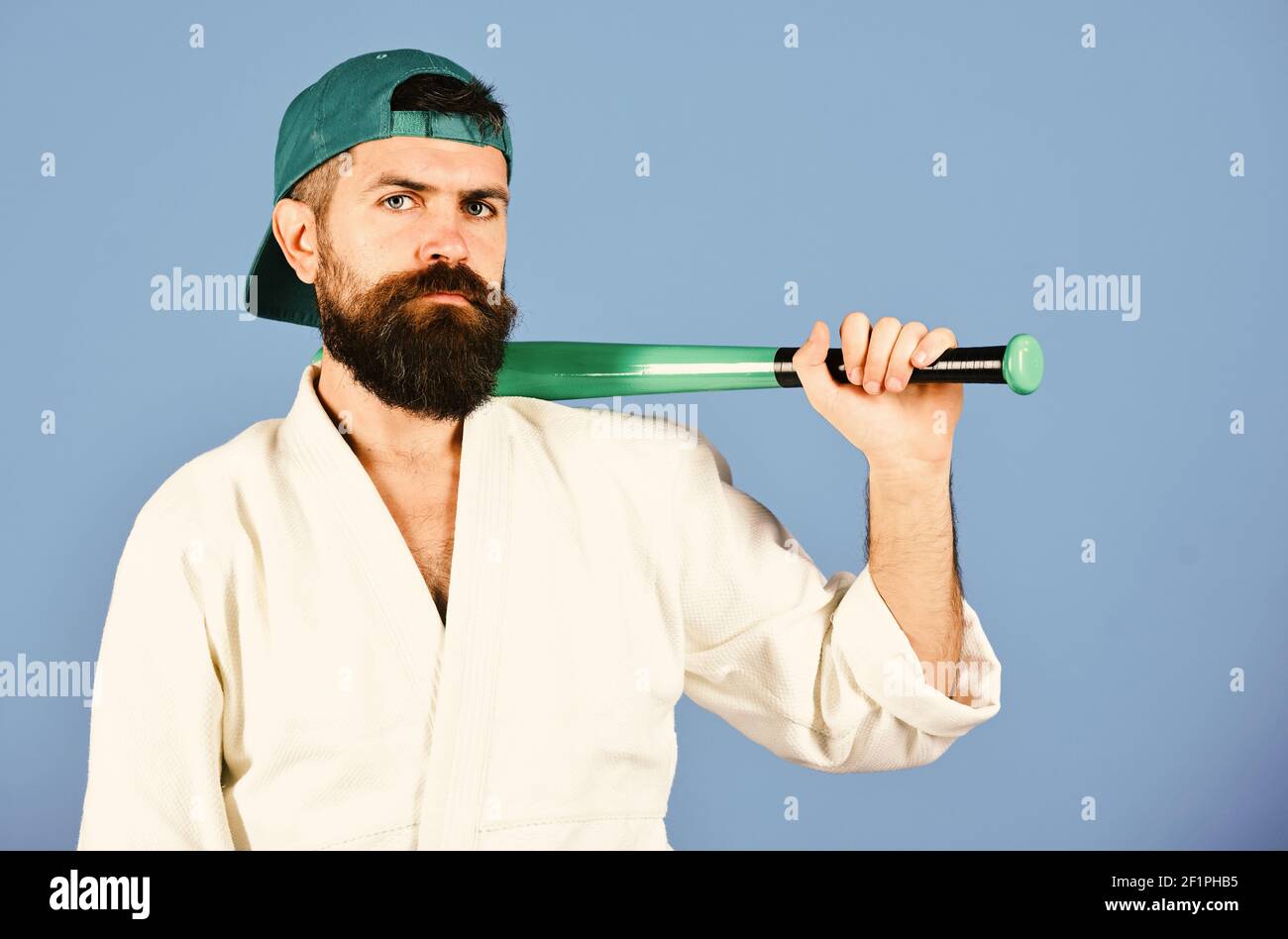 Violence and bullying concept. Karate man with serious face holds green ...