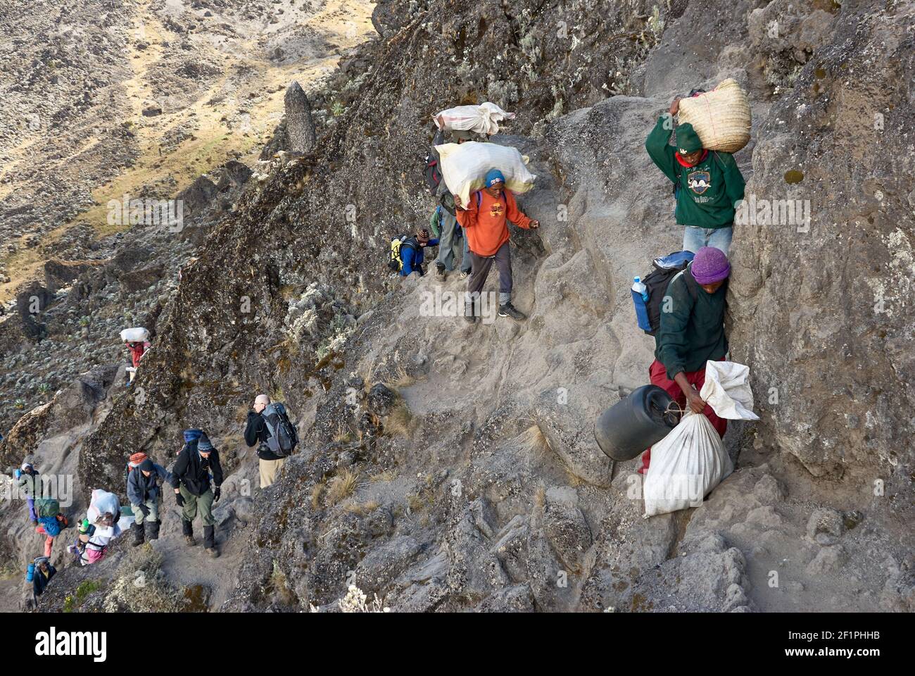 porters with baggage climbing in Barranco Wall on their way up to MOUNT ...