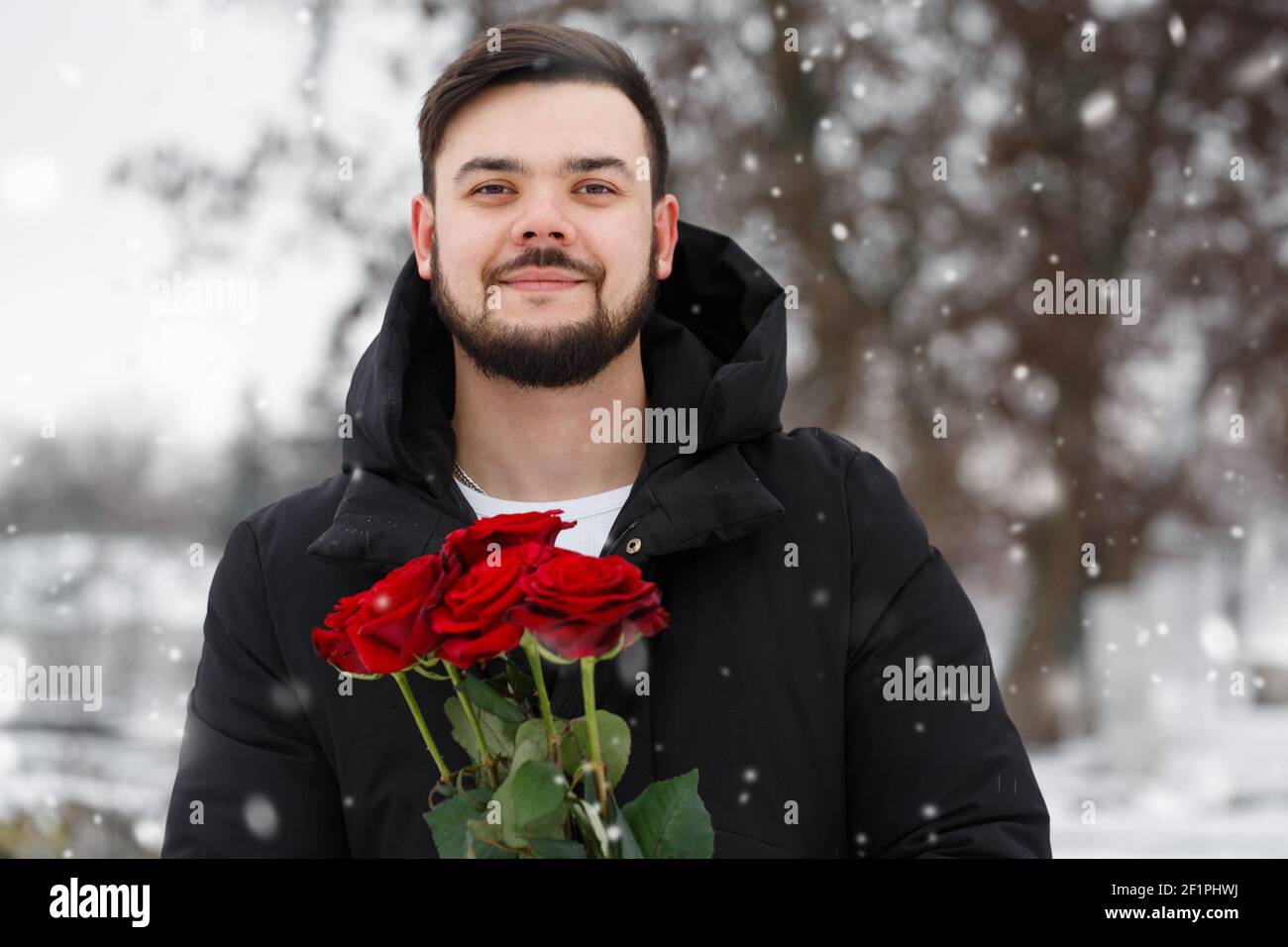 Romantic couple embracing in snowy hi-res stock photography and images ...