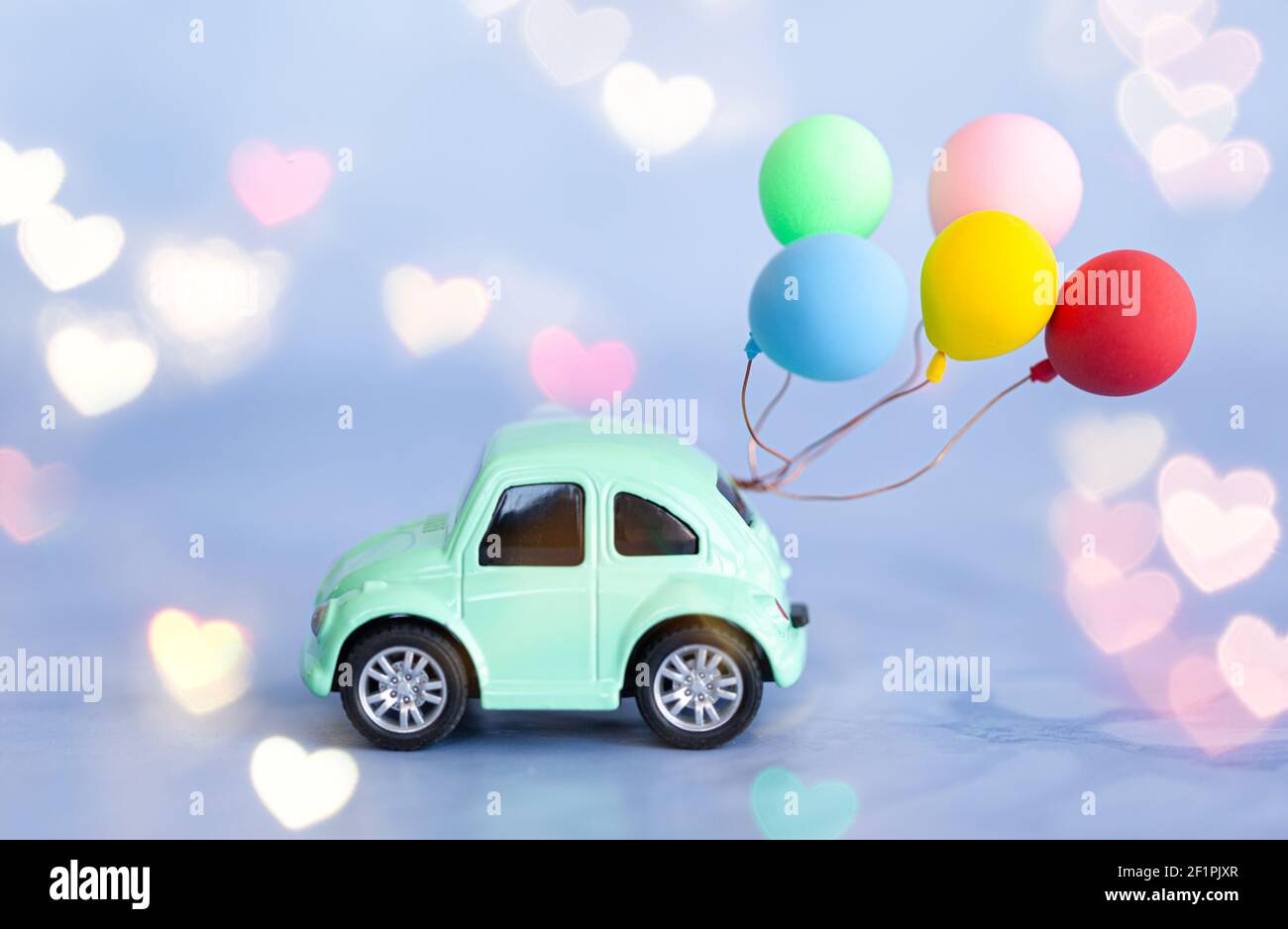 Small green car with balloons Stock Photo - Alamy