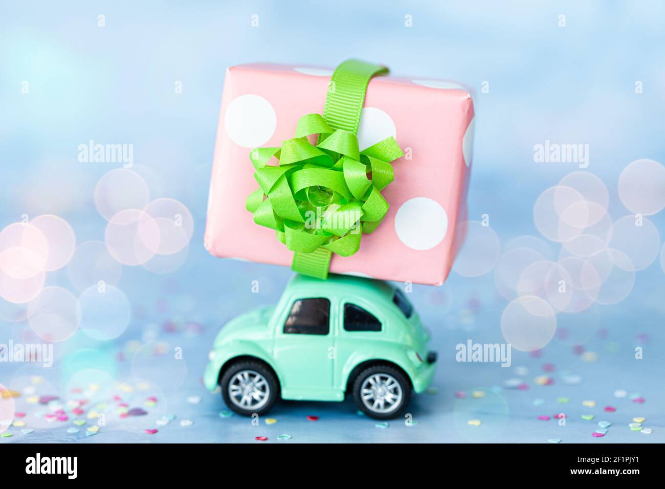 Small green car with gift Stock Photo - Alamy