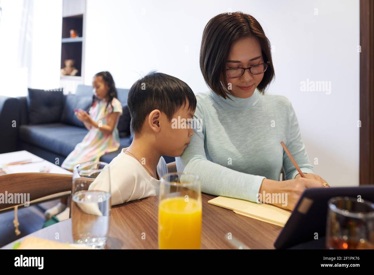 Mother explaining difficult topic to little son when teaching him math ...