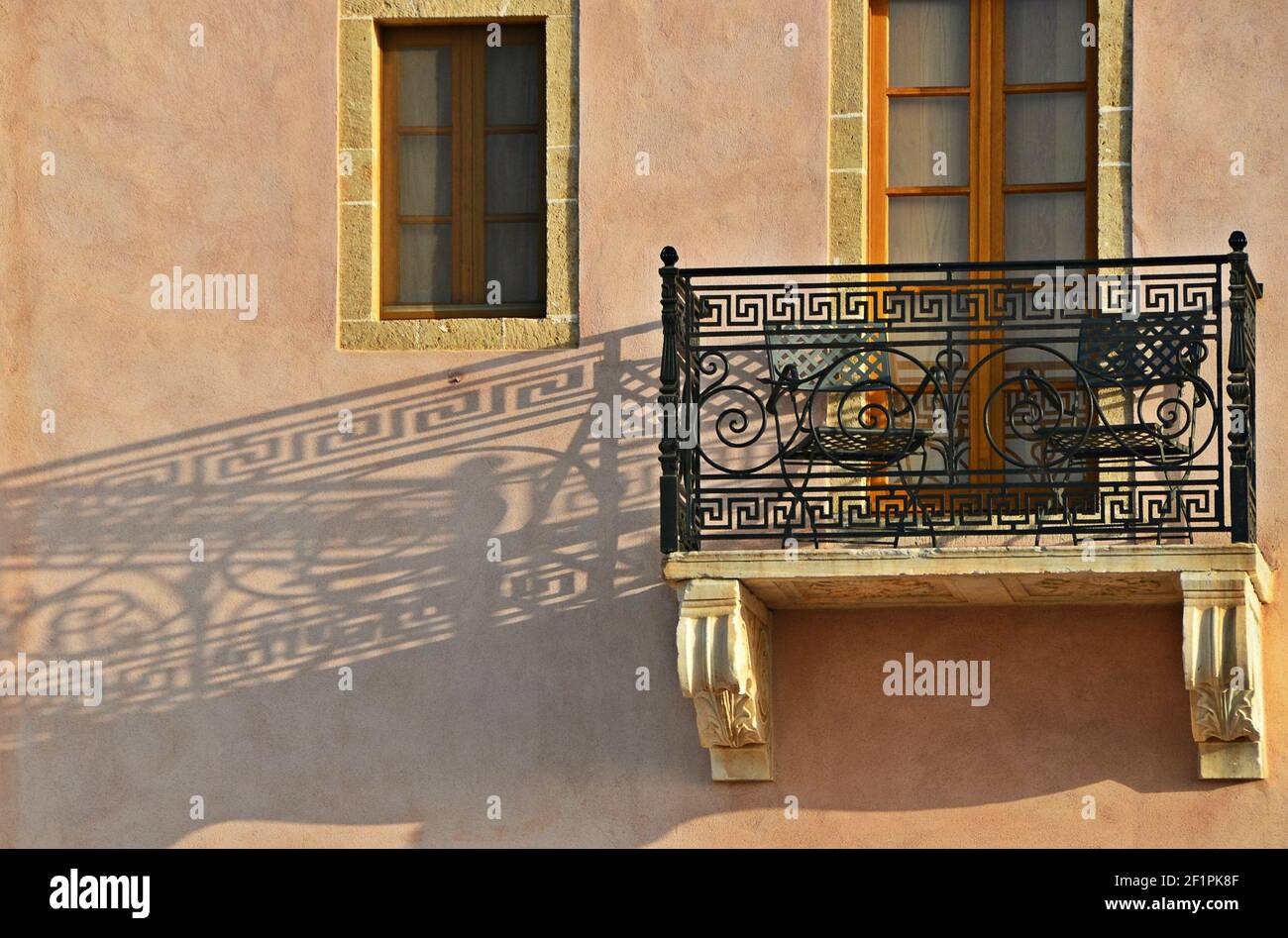 Venetian house facade with a coral pink stucco wall and handcrafted ...