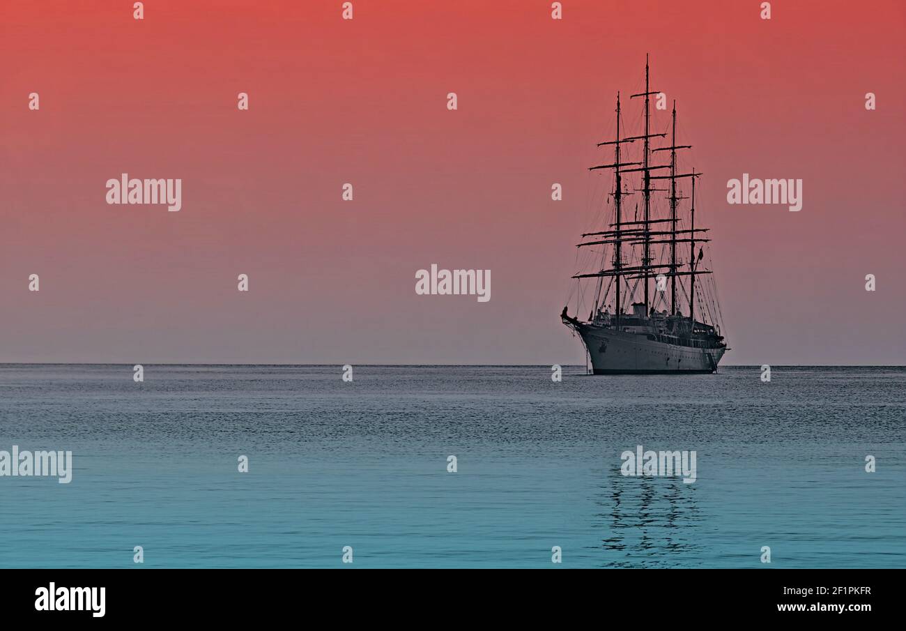 Sunrise seascape with view of Sea Cloud, a historic 4 masted sailing ...