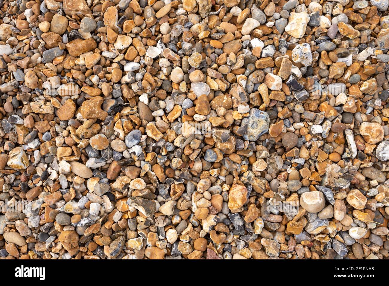 Different coloured pebbles on a beach Stock Photo - Alamy