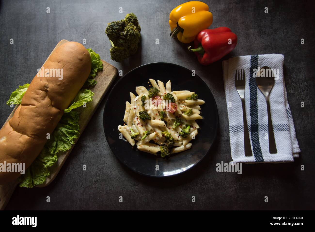 Popular Italian dish cheese penne pasta and bread loaf Stock Photo - Alamy