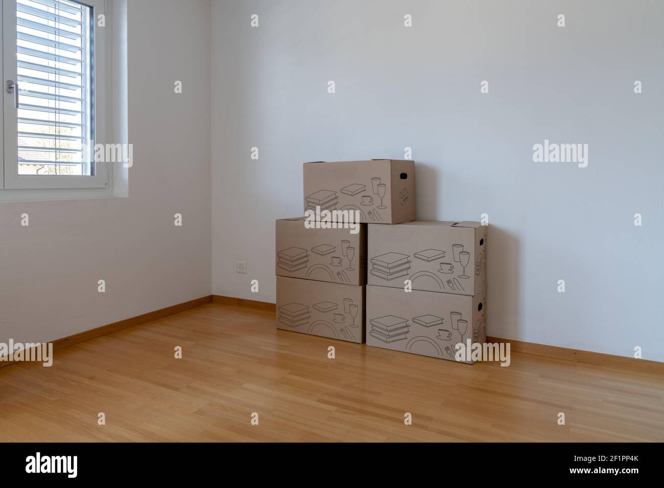 Large brown moving and packing boxes in an empty room Stock Photo - Alamy