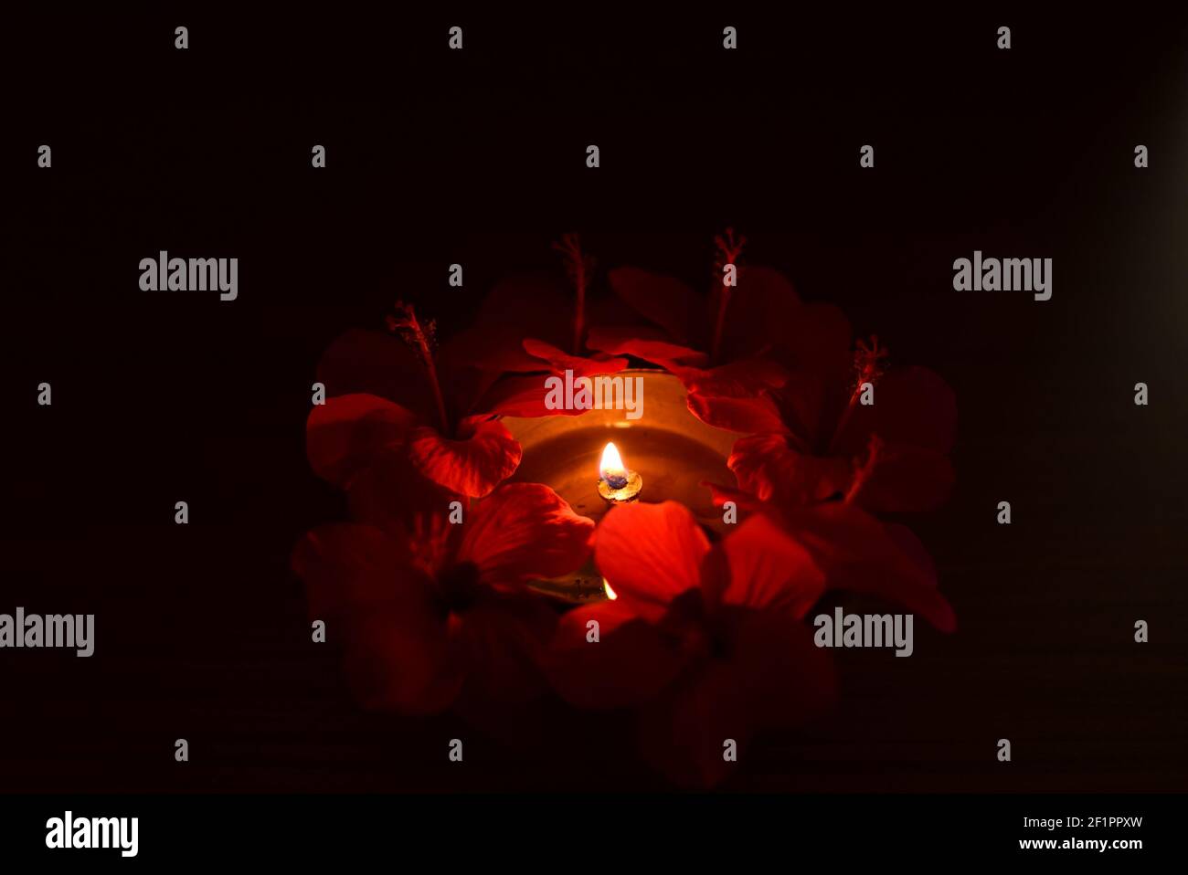 Red flowers and lamp, Holi celebration scene Stock Photo - Alamy
