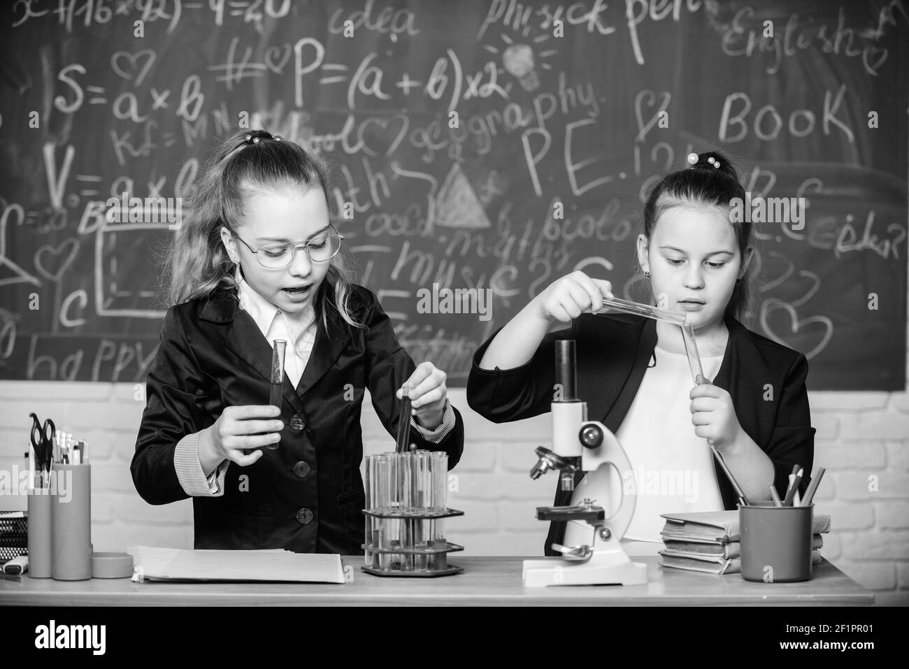 For a better tomorrow. Little girls genius in school lab. Science lab ...