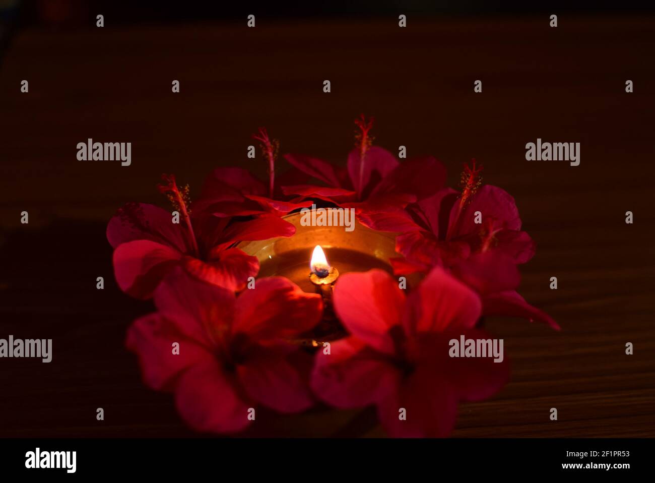Red flowers and lamp, Holi celebration scene Stock Photo - Alamy