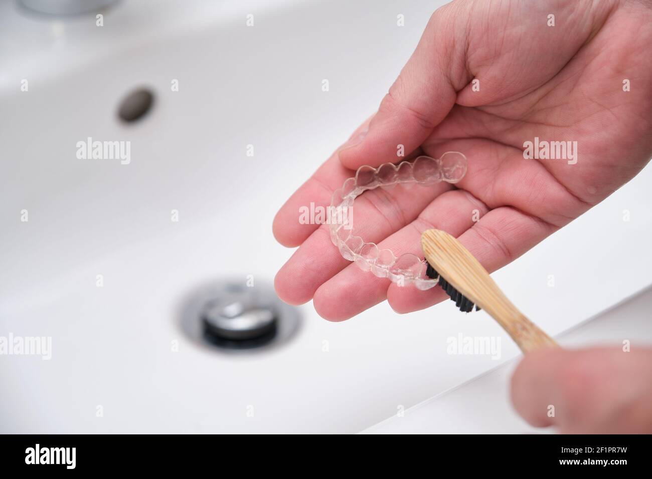 Cleaning tooth aligners. Washing and removing organic residues with a ...