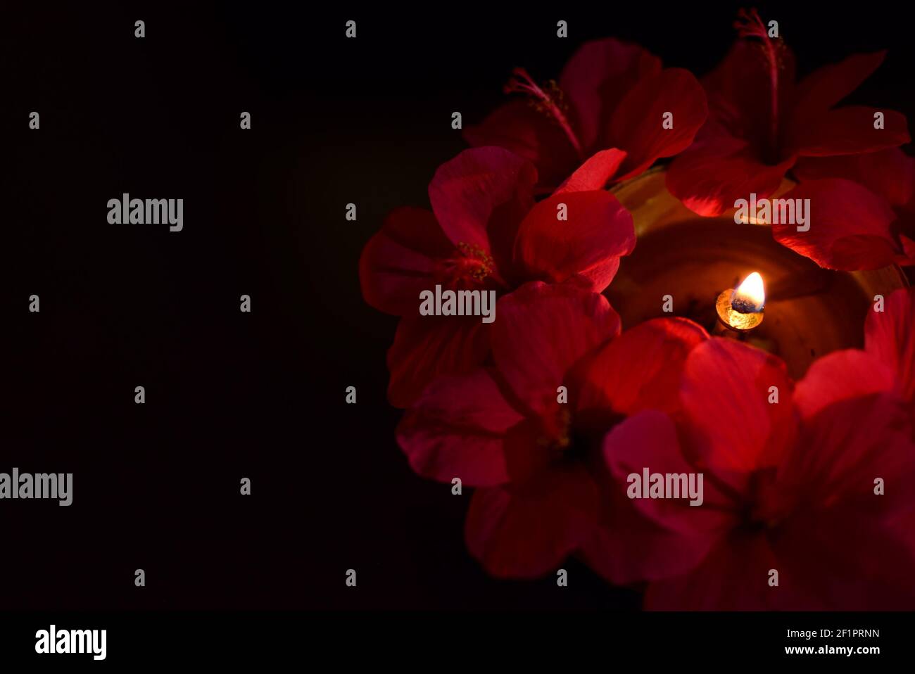 Red flowers and lamp, Holi celebration scene Stock Photo - Alamy