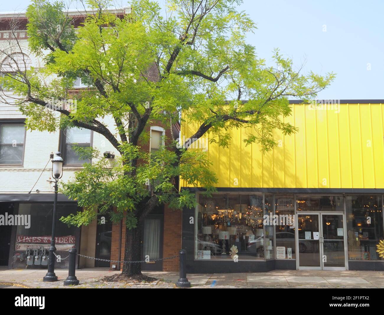 The store has bright yellow on its roof Stock Photo - Alamy