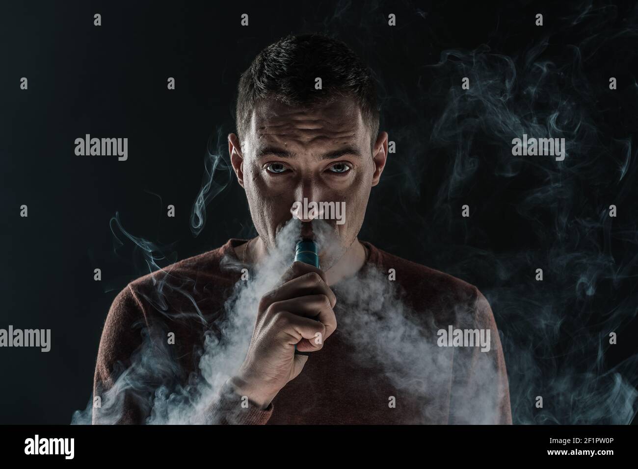 man smokes vape smoke Electronics vaping nicotine Stock Photo - Alamy