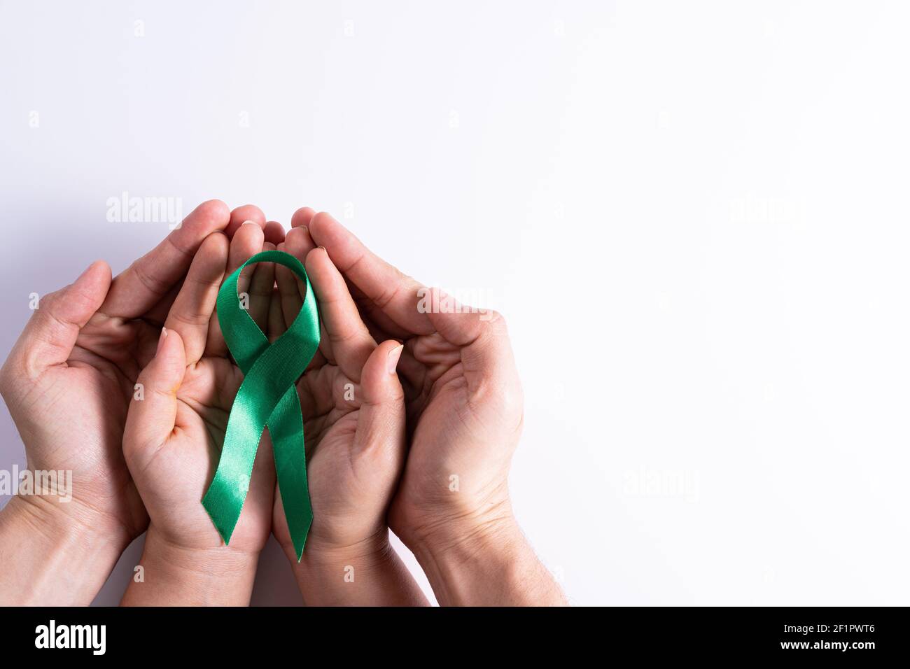 World kidney day, man and woman hands holding green ribbon awareness of ...