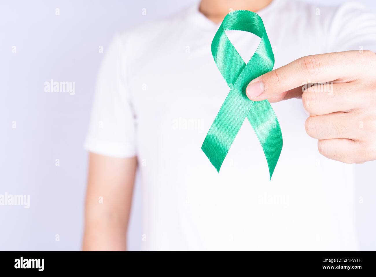 World kidney day, hands holding green ribbon awareness of kidney ...