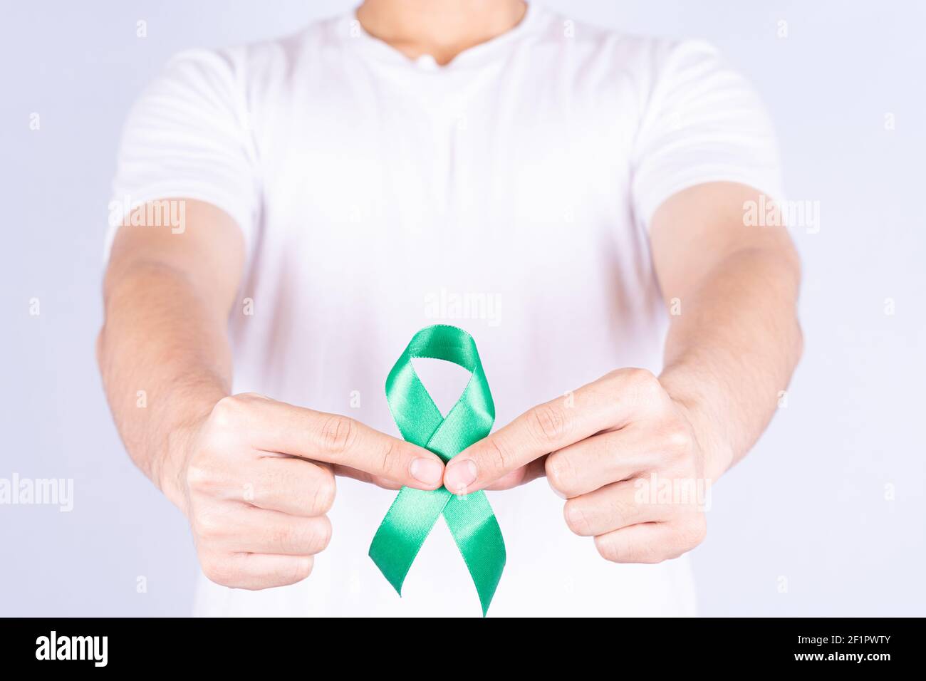 World kidney day, hands holding green ribbon awareness of kidney ...