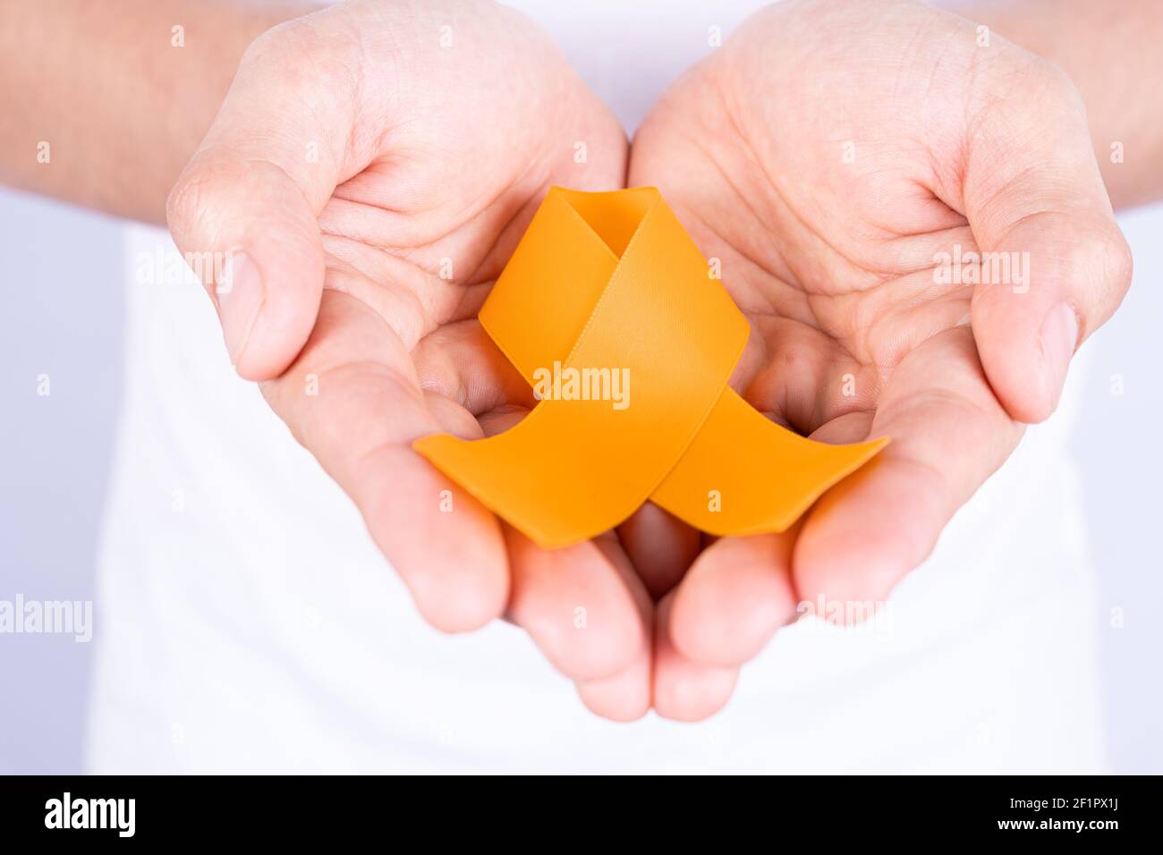 World kidney day, hands holding orange ribbon awareness of kidney ...