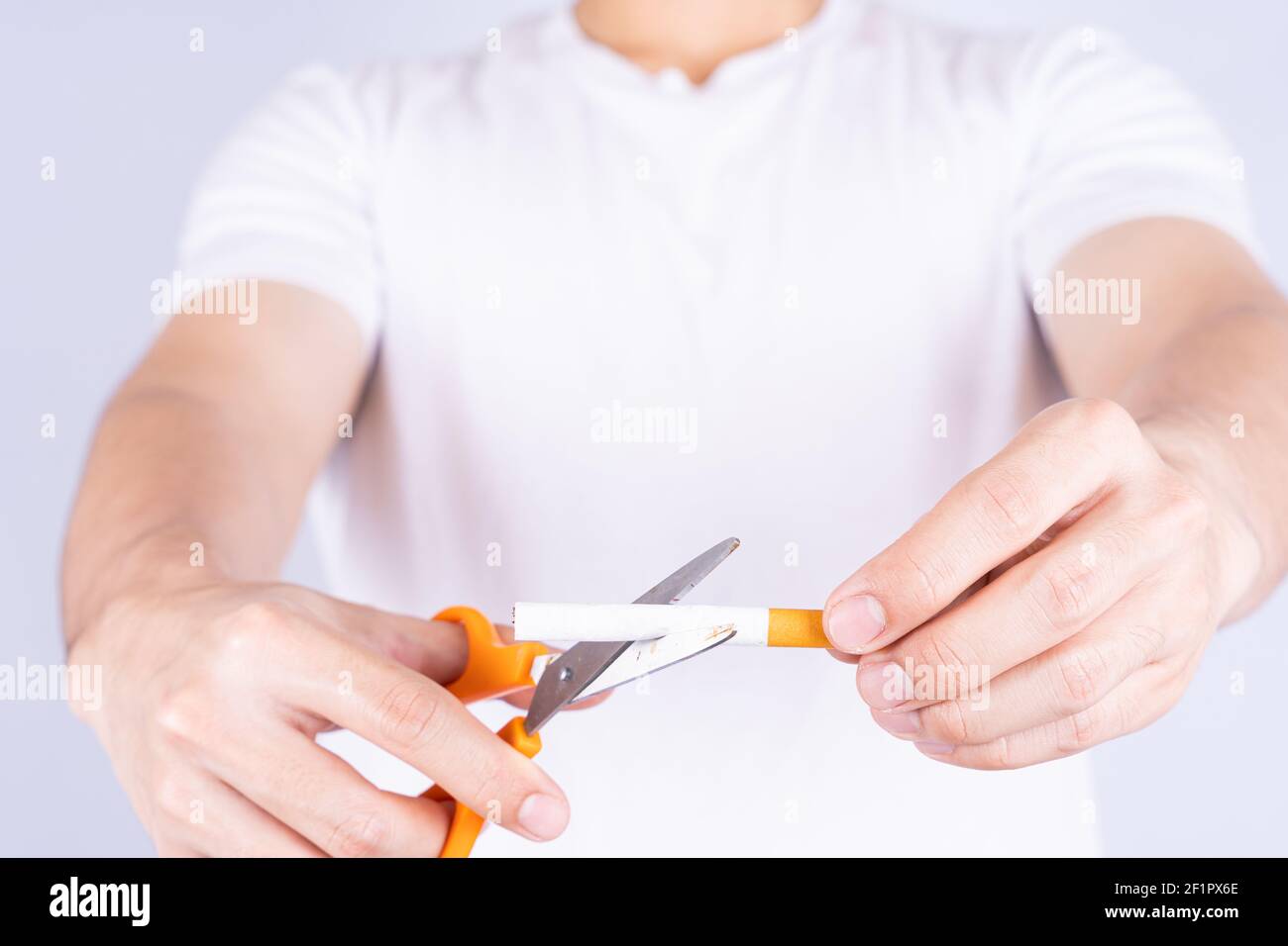 Male hand using scissors cutting cigarette. World no Tobacco and stop ...