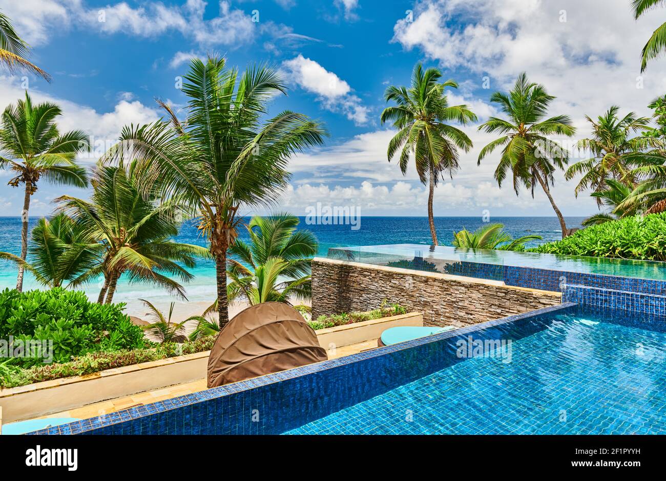 Beach with resort swimming pool at Seychelles Stock Photo - Alamy