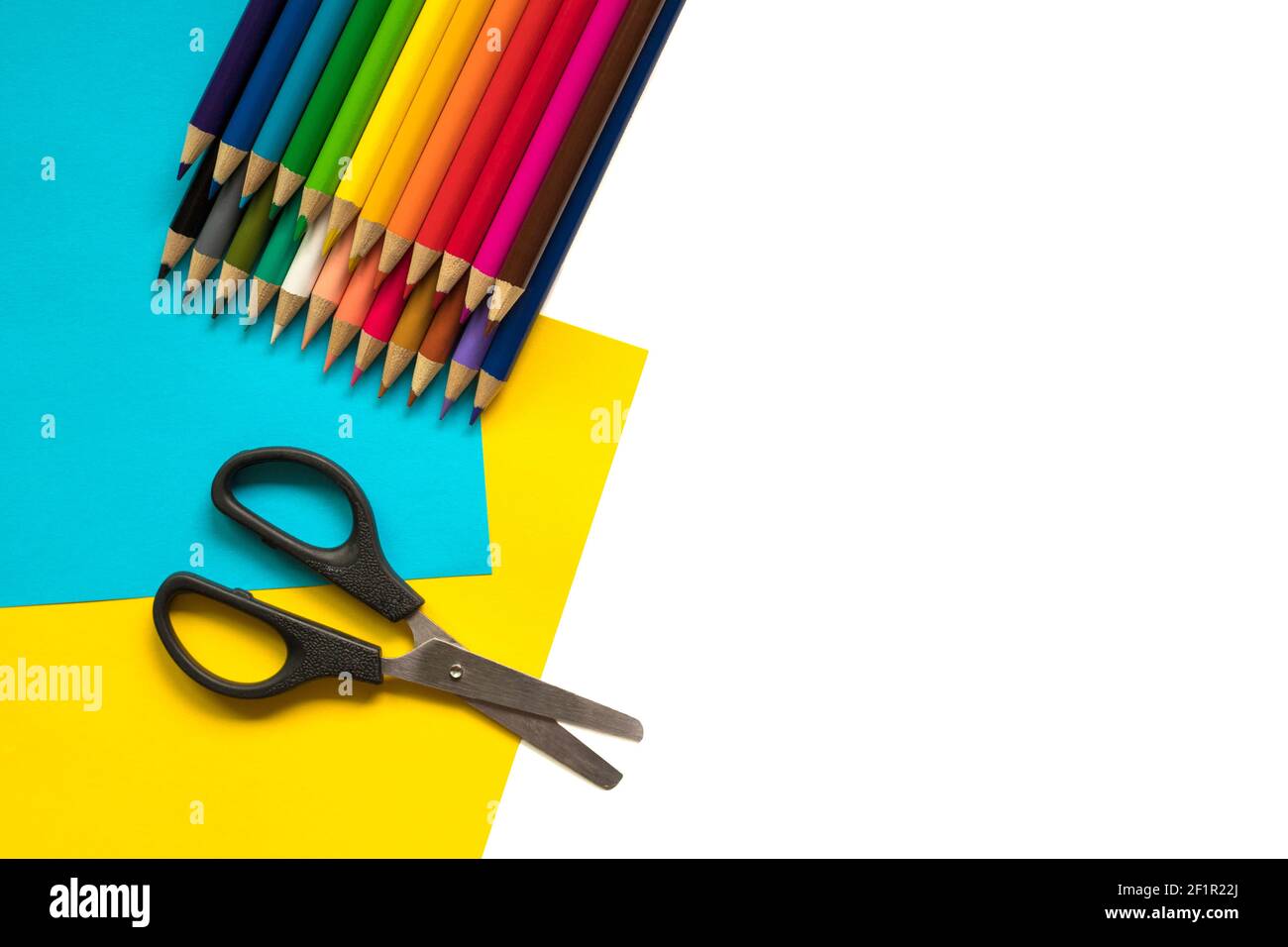 Colorful pencils, scissors on paper and white background. Back to ...