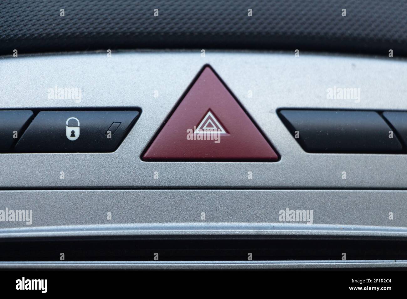 Red warning button on the dashboard of a car Stock Photo - Alamy
