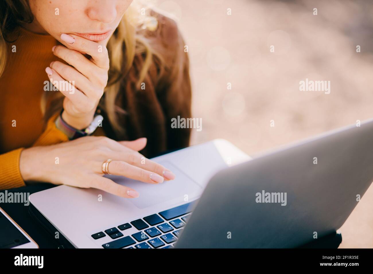 concentrated serious woman entrepreneur work on laptop outdoors in cafe ...