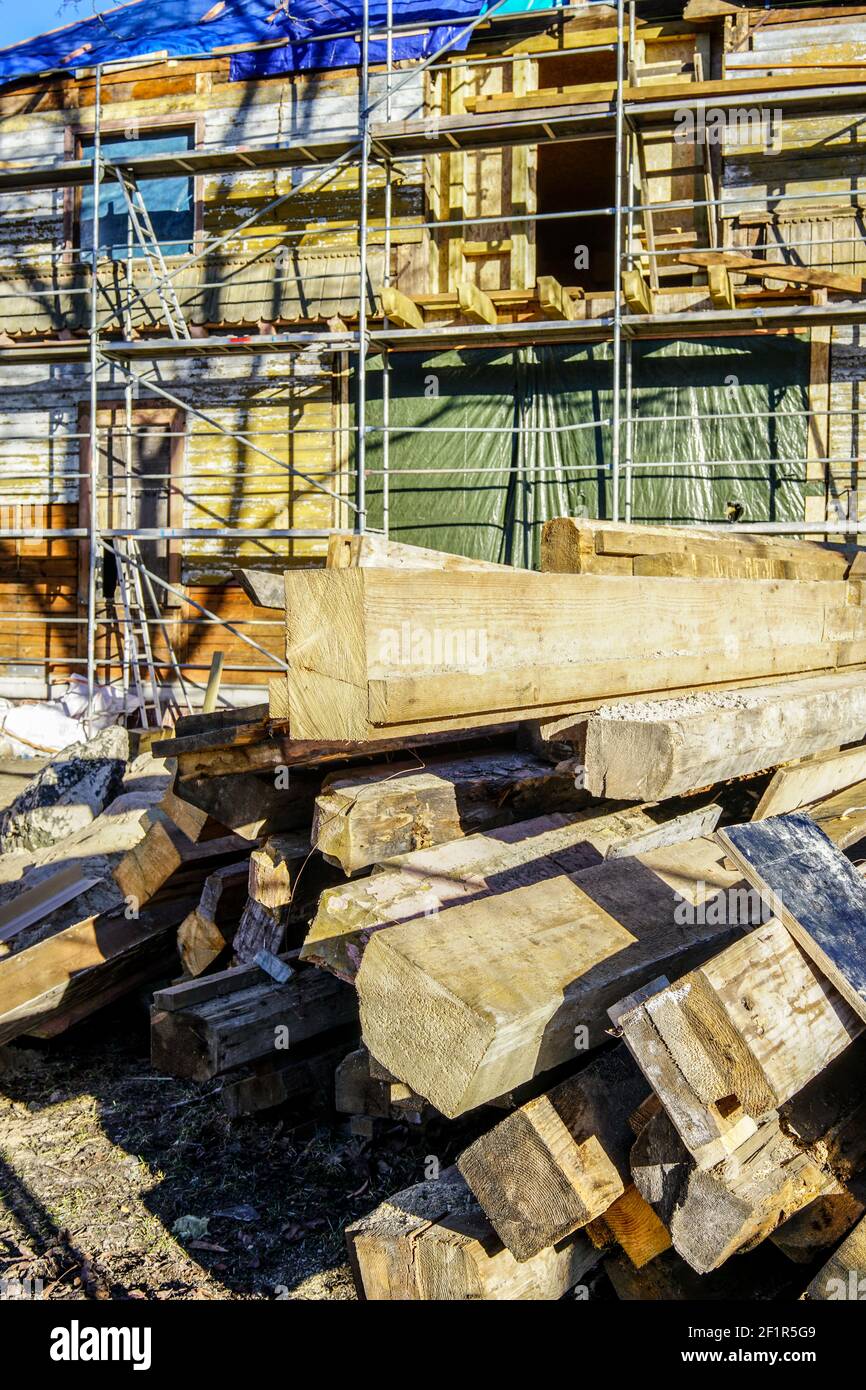 a pile of used wooden building materials for reuse in a wooden house ...
