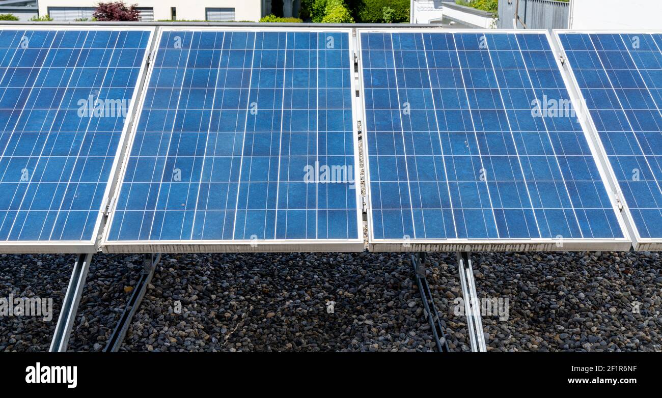 A close up view of a row of modern solar panels on a flat rooftop Stock ...